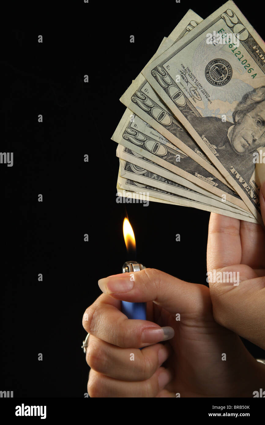 Two Hands Burning $20 Dollar Bills with a Lighter Stock Photo - Alamy