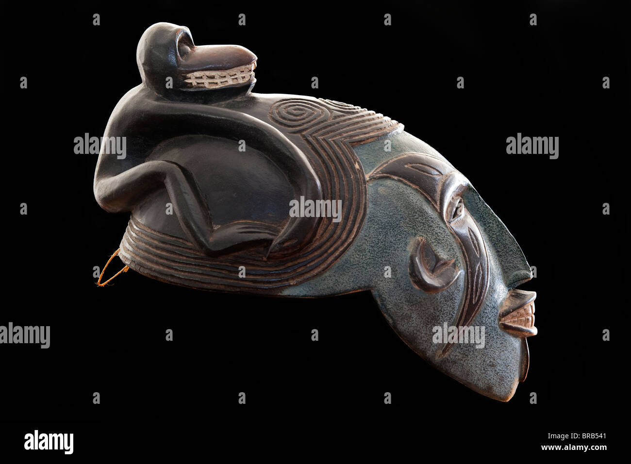 Wooden carved African tribal mask, shoot from the side, dark wood with ...