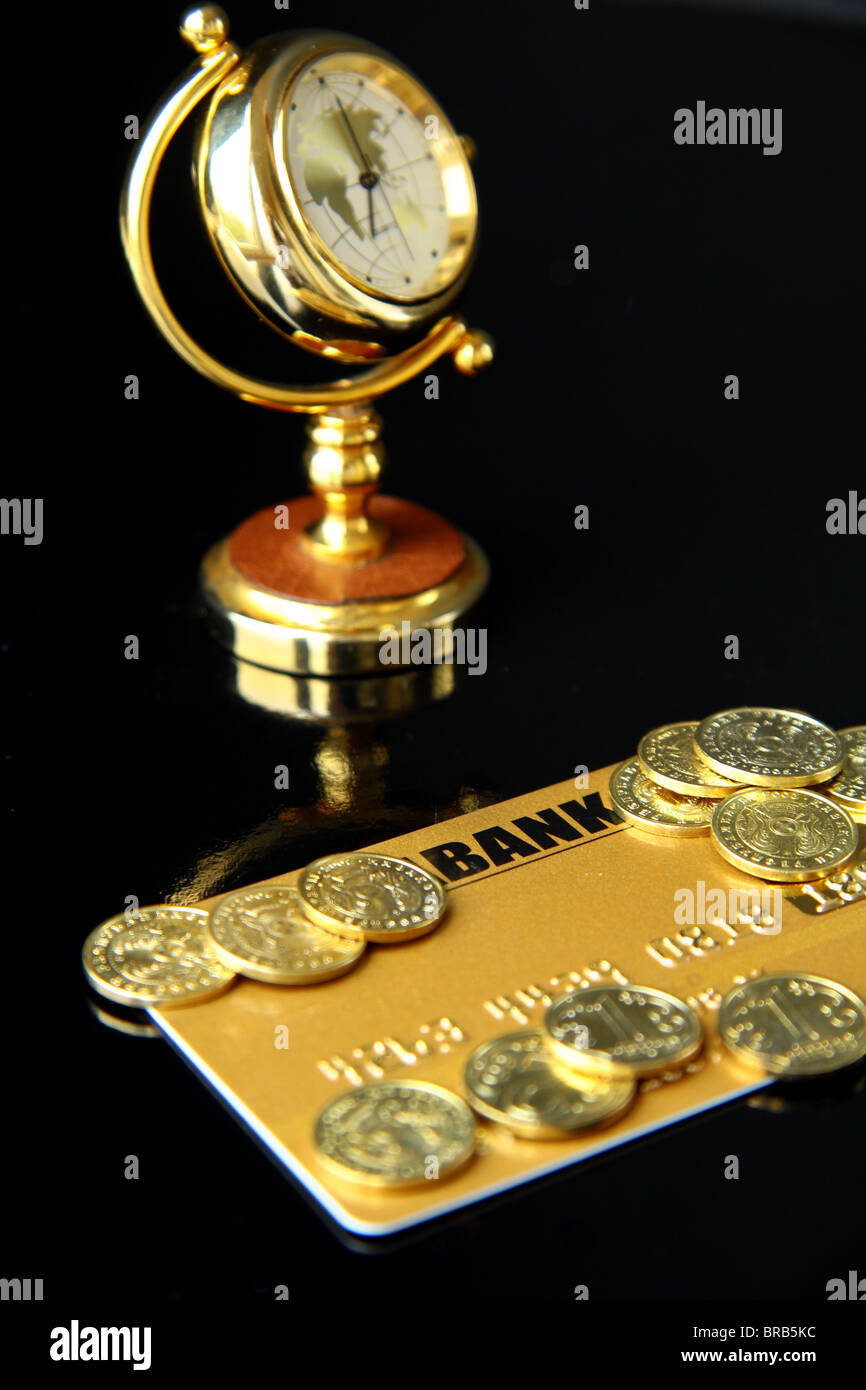 Gold credit card and watch on a black background Stock Photo - Alamy