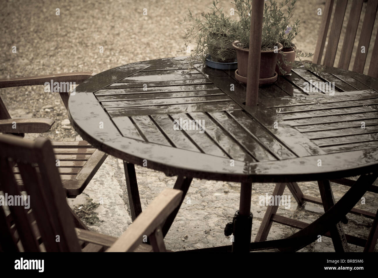 Garden Table in the Rain Stock Photo - Alamy