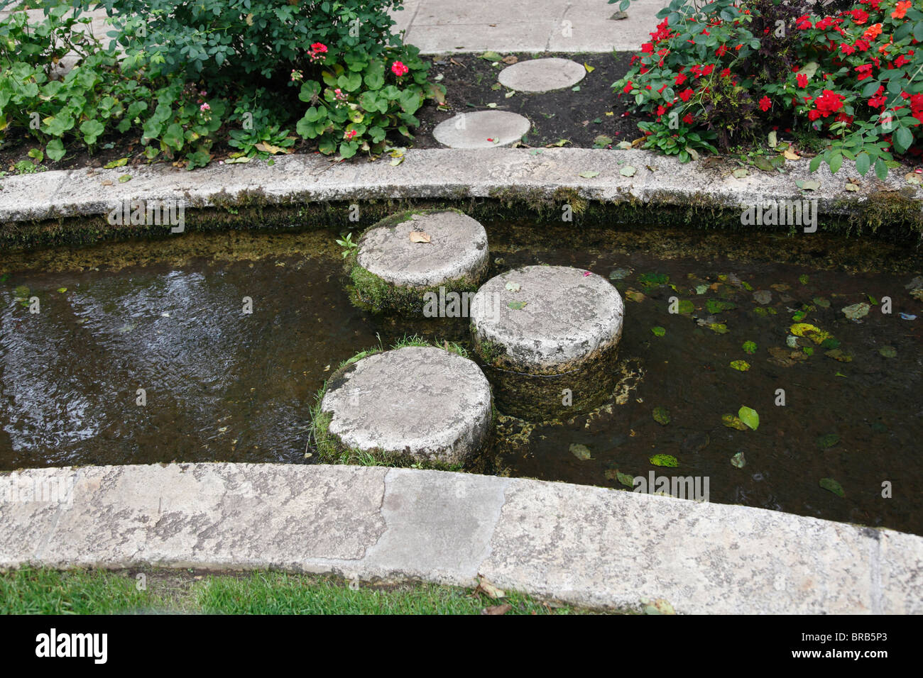 Stepping stones crossing a stream in a garden Stock Photo - Alamy