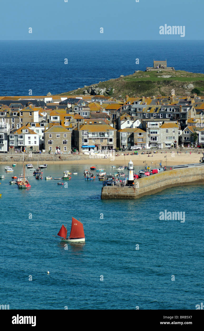 Red sailing boat leaving St. Ives harbour, Cornwall UK Stock Photo - Alamy