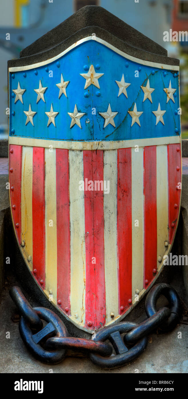 An HDR image of a metal american flag emblem at the base of a memorial ...