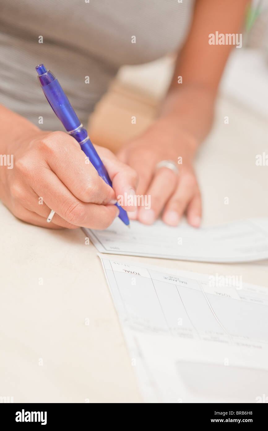woman's hand writing checks Stock Photo - Alamy