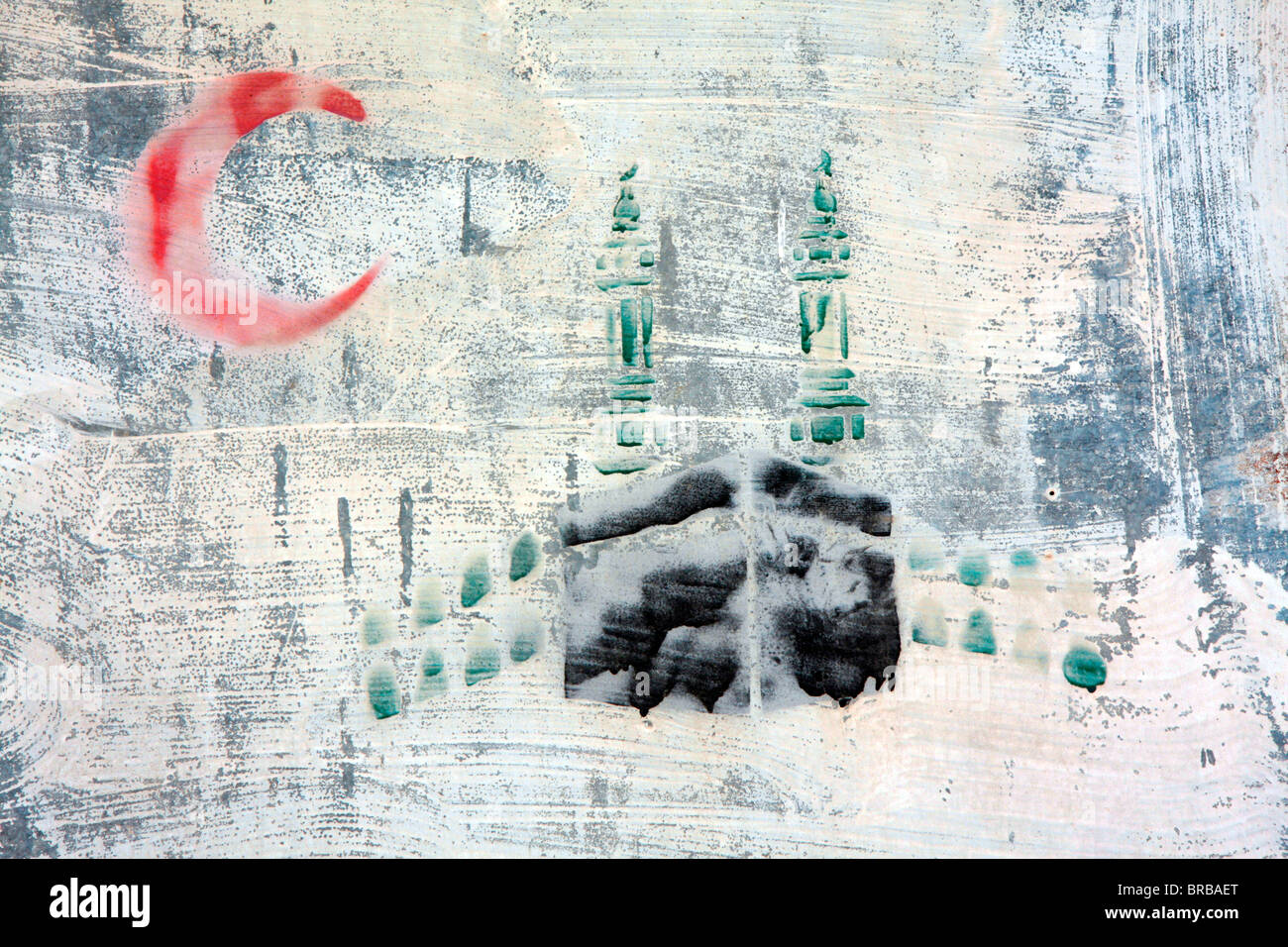 Spray-paint stencil of a muslim crescent and Mecca on an old metal gate ...
