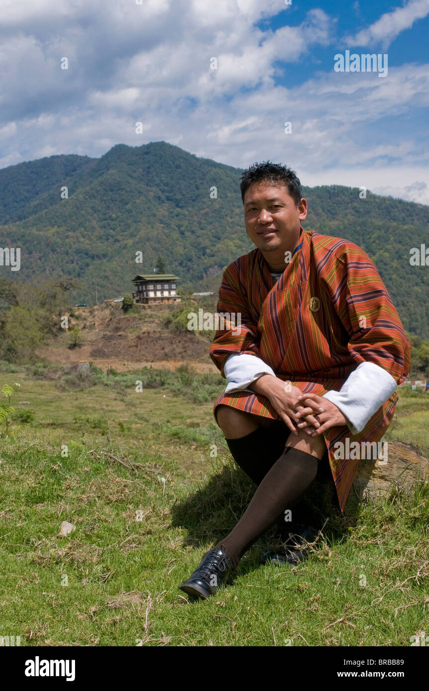 Traditionally dressed man enjoying view over mountains around Dochu La ...