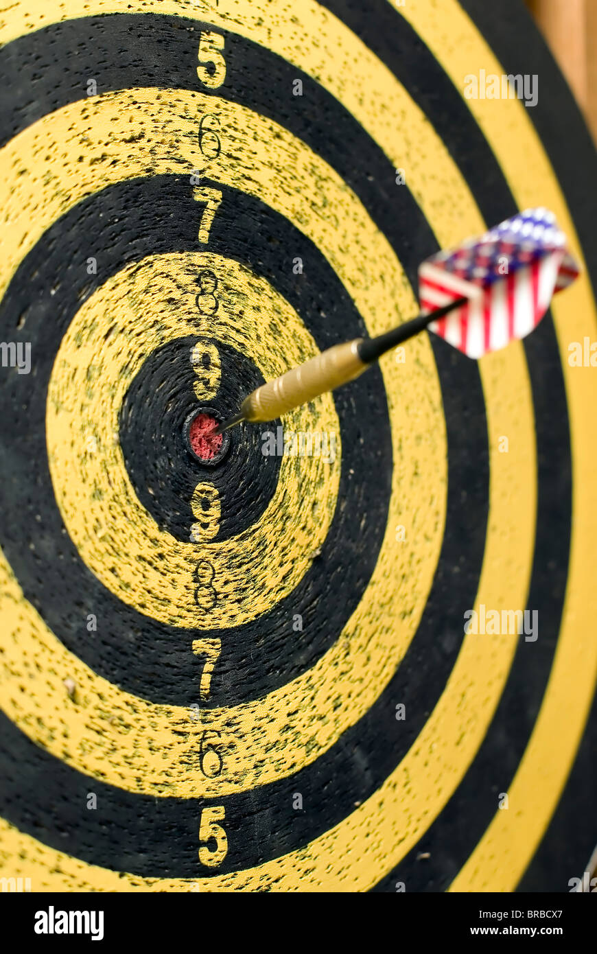Dart with usa flag in the center of red aim Stock Photo - Alamy