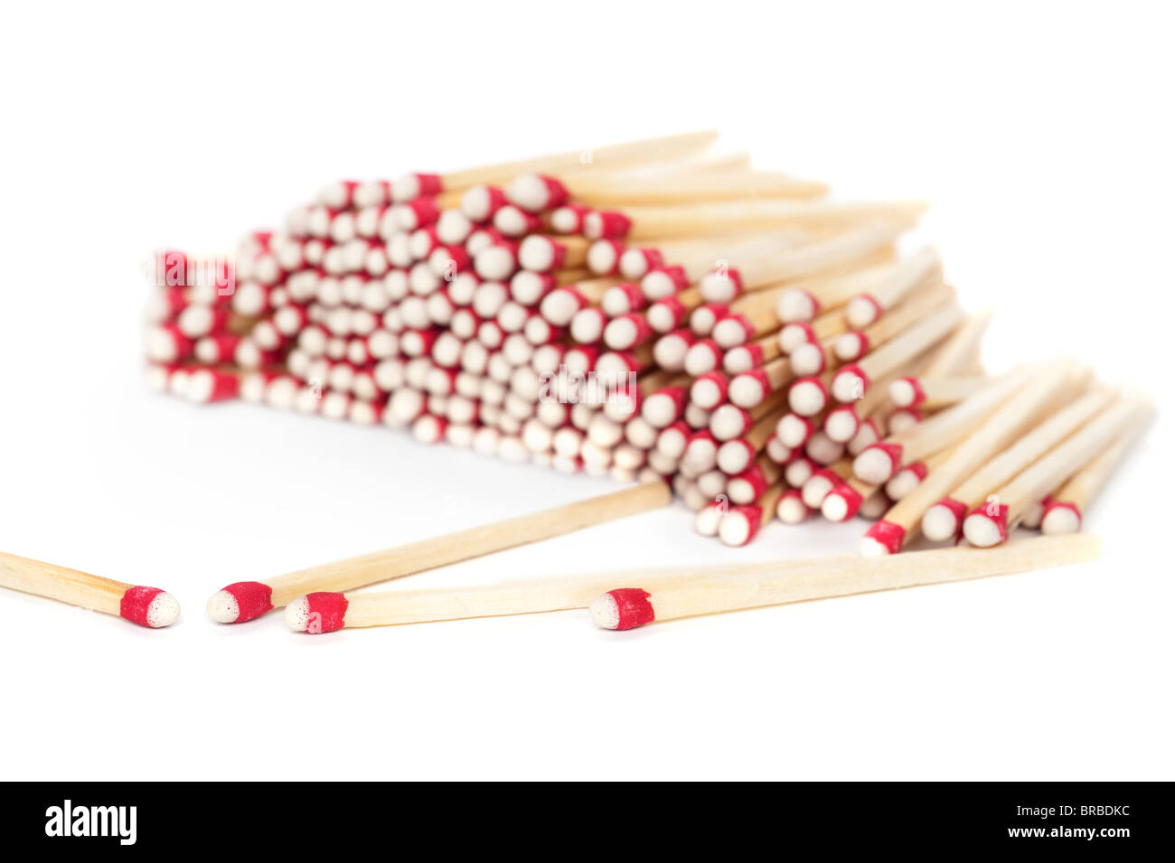 A stack of matchsticks on a white background with selective focus on ...
