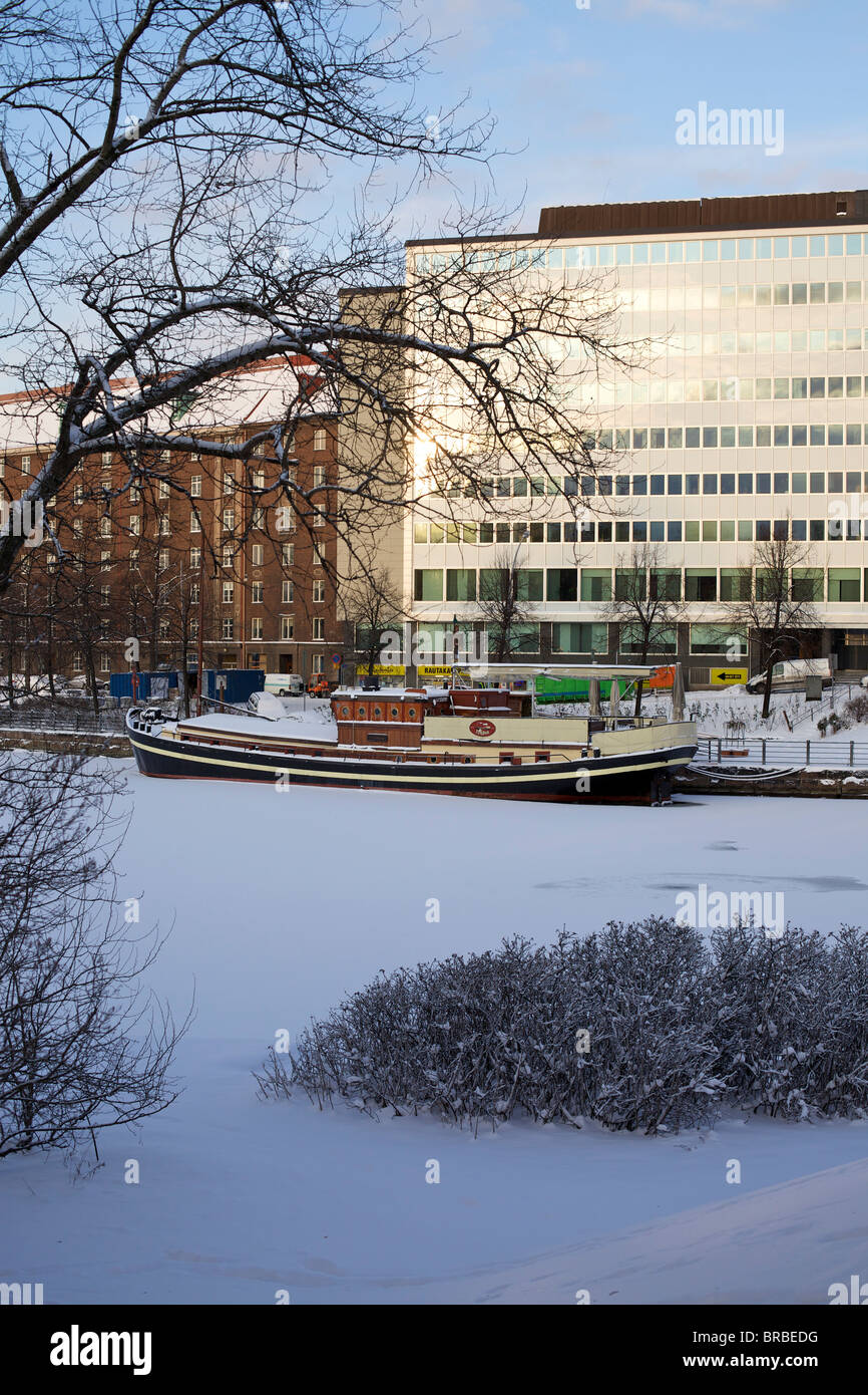 Boat on the frozen river seen from Pitkasilta Bridge, Helsinki, Finland ...