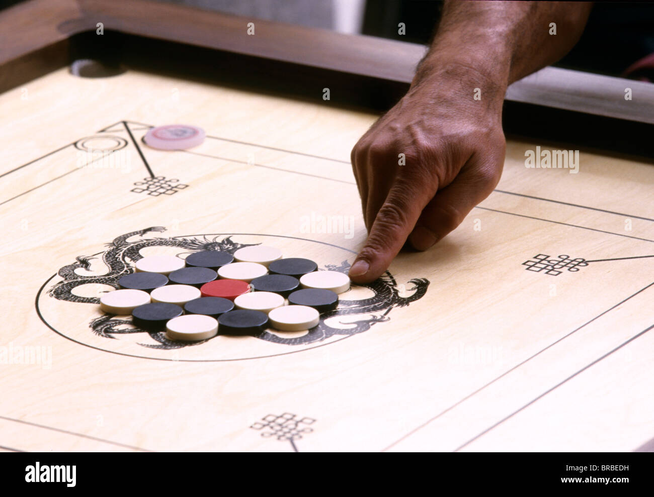 Board game showing mans hand moving checker Stock Photo - Alamy