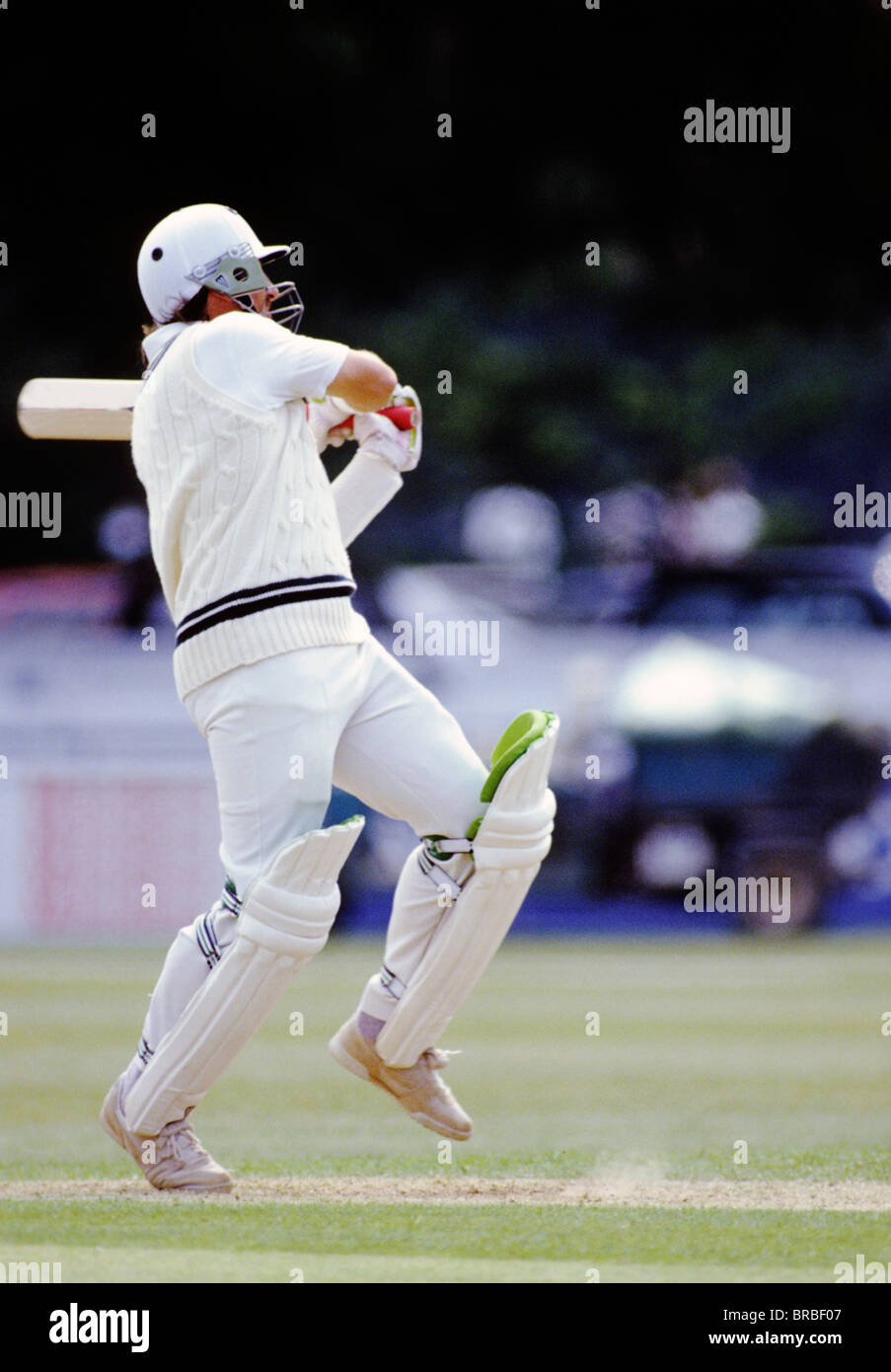 Man swinging bat while playing cricket Stock Photo - Alamy