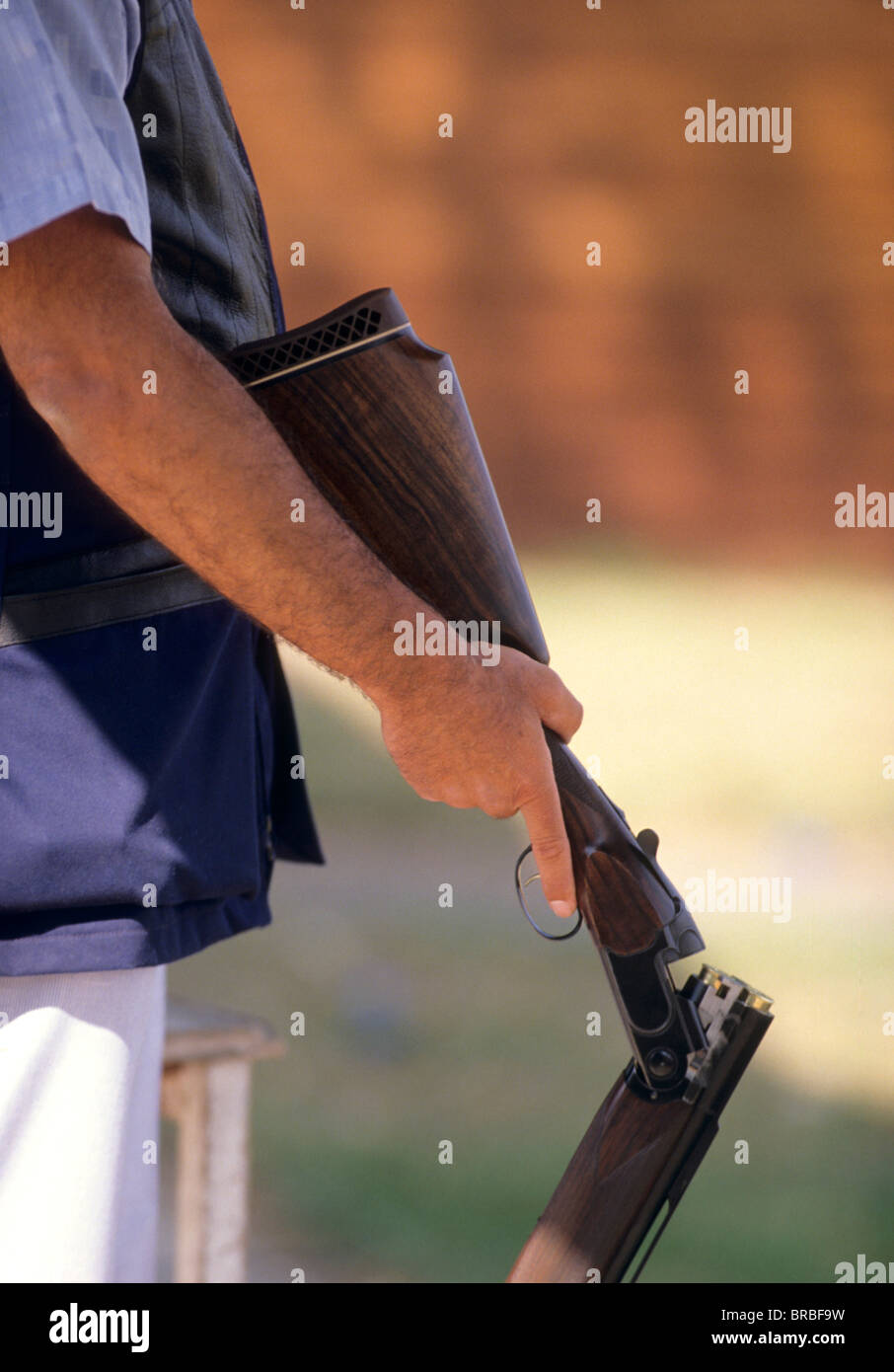 Man holding a loaded open shotgun Stock Photo - Alamy