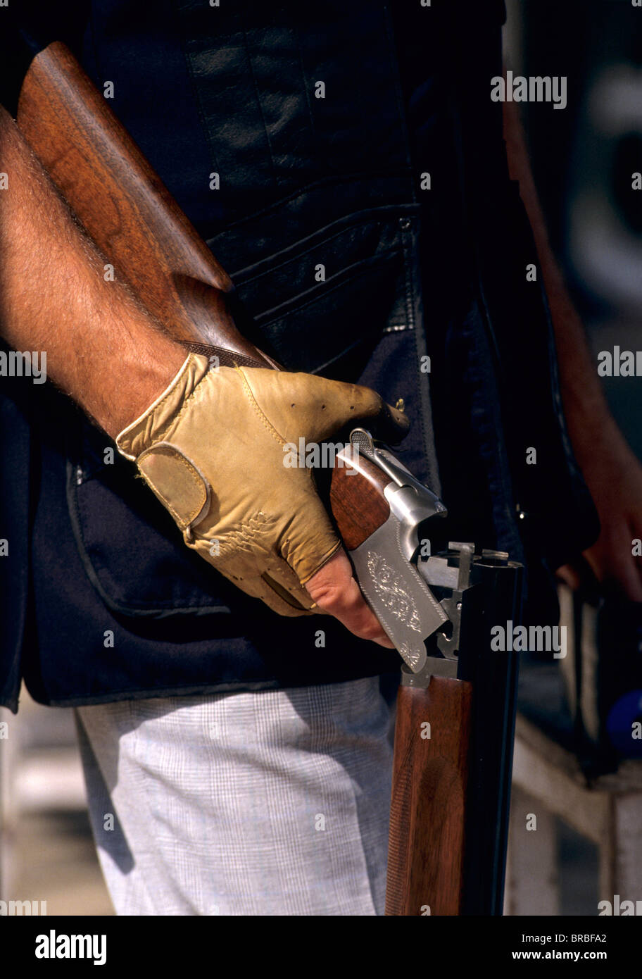 Man walking with loaded gun Stock Photo - Alamy