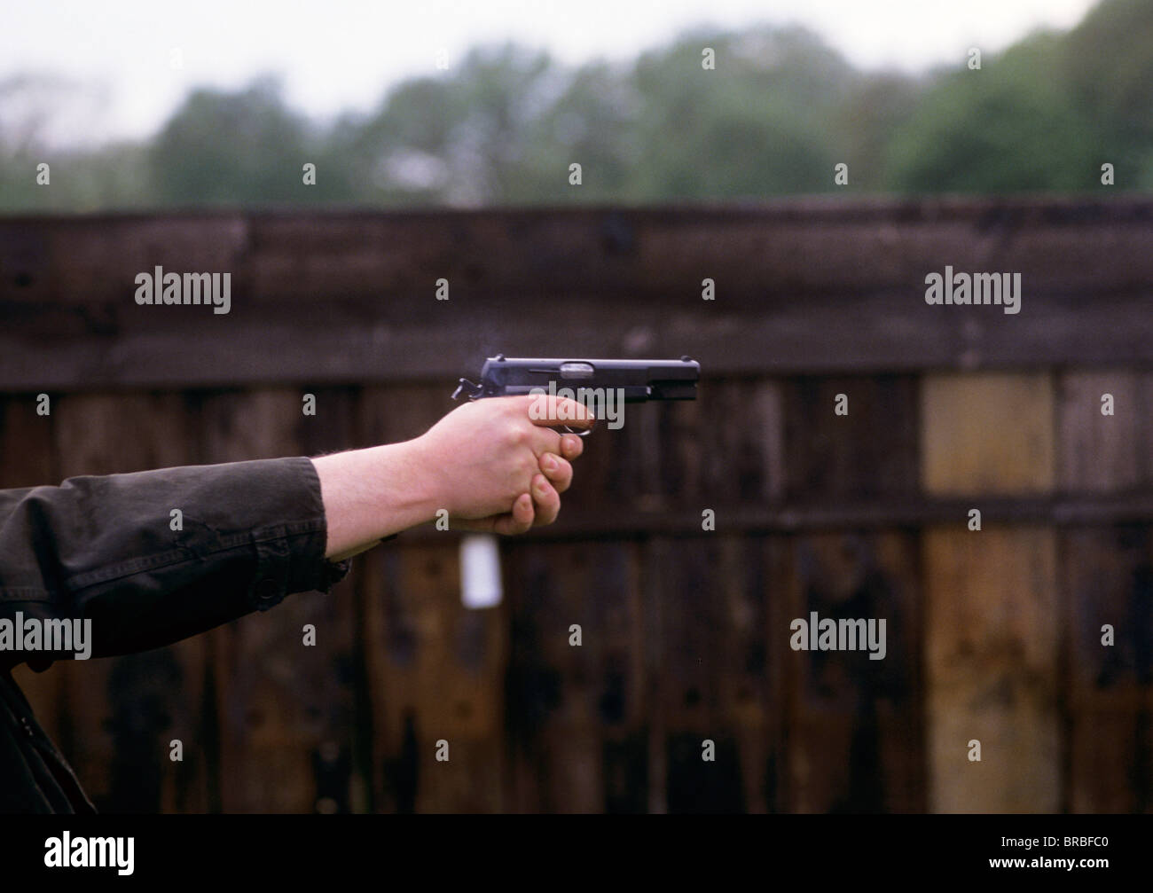 Person aiming handgun Stock Photo - Alamy