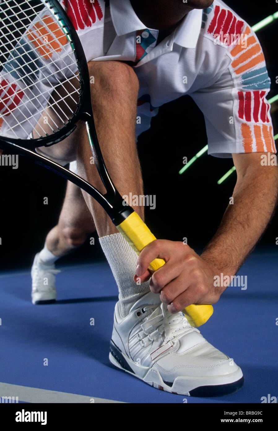 Tennis player stoops to return a ball Stock Photo - Alamy