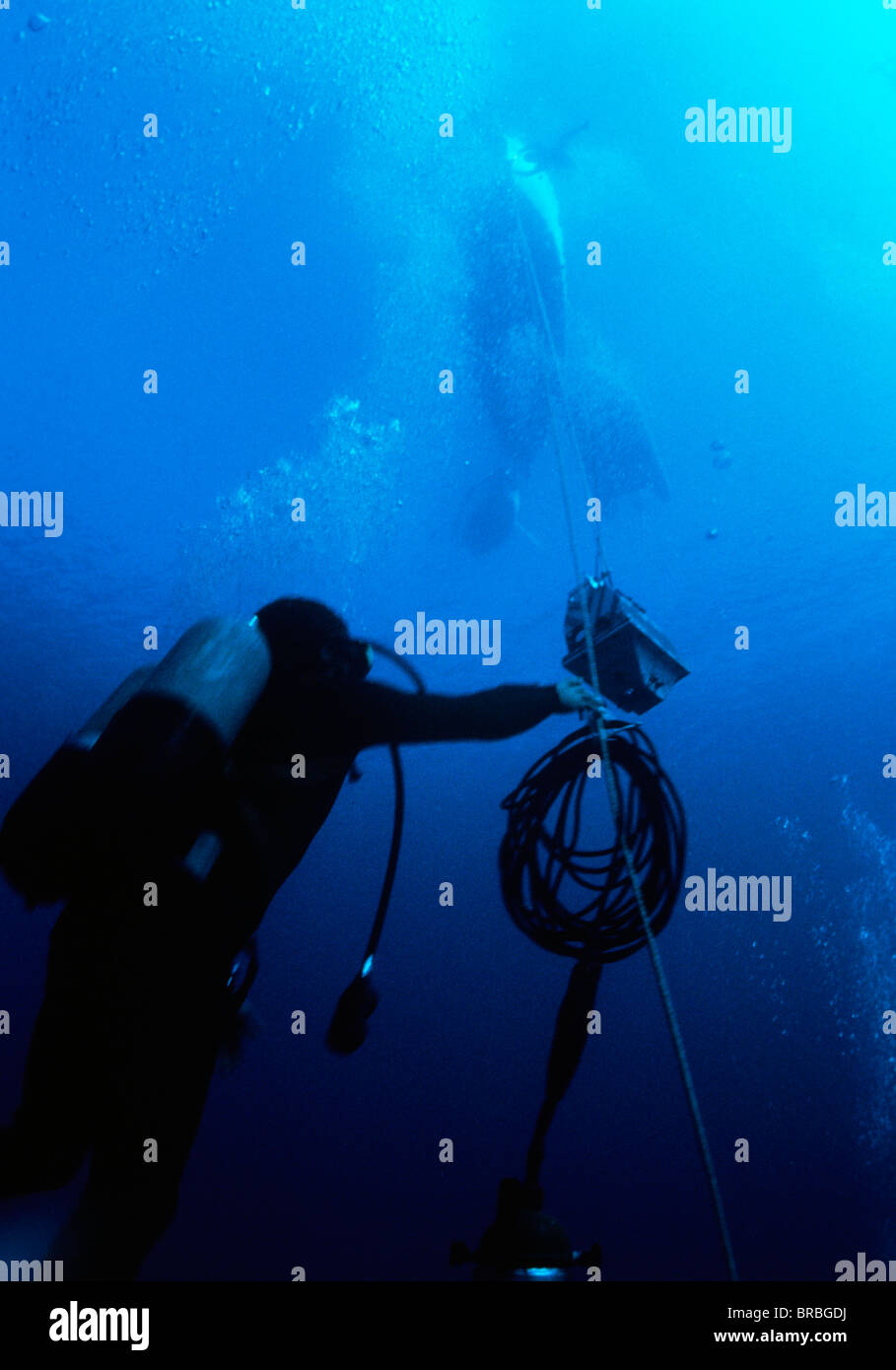 Deep sea diver stops at depth distance marker on climb to surface Stock ...