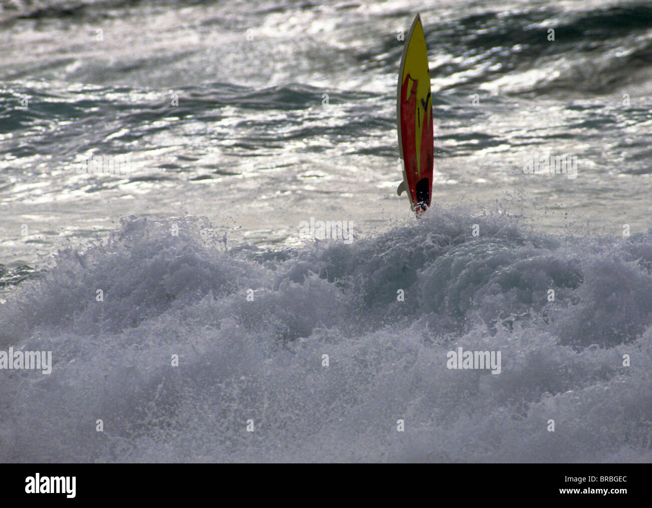 Surfers bail out on huge wave as it crashes to beach Stock Photo - Alamy