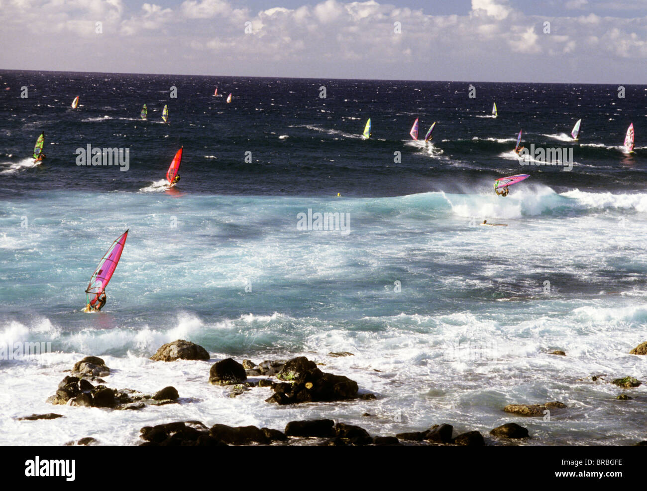 Group of windsurfers offshore in waves Stock Photo - Alamy