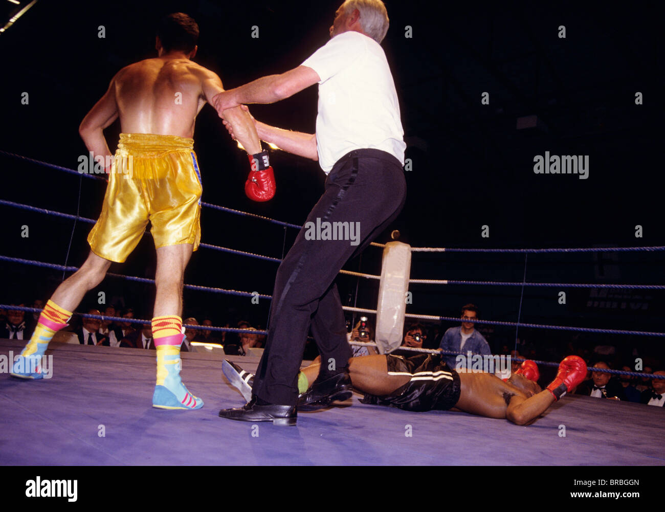 Two boxers exchange punches in ring and one is knocked down Stock Photo ...