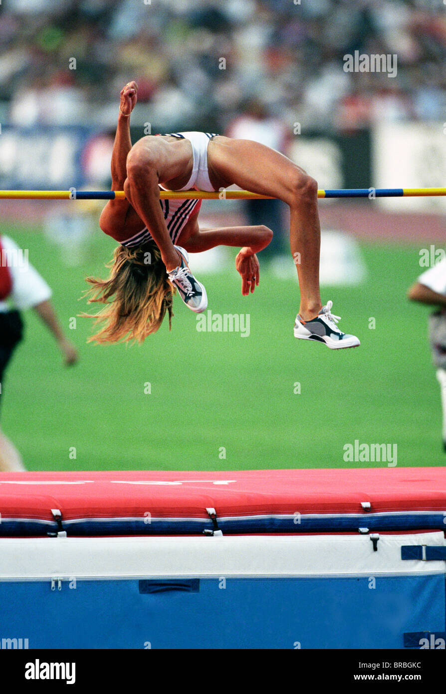 Female high-jumper clears bar on her jump Stock Photo - Alamy