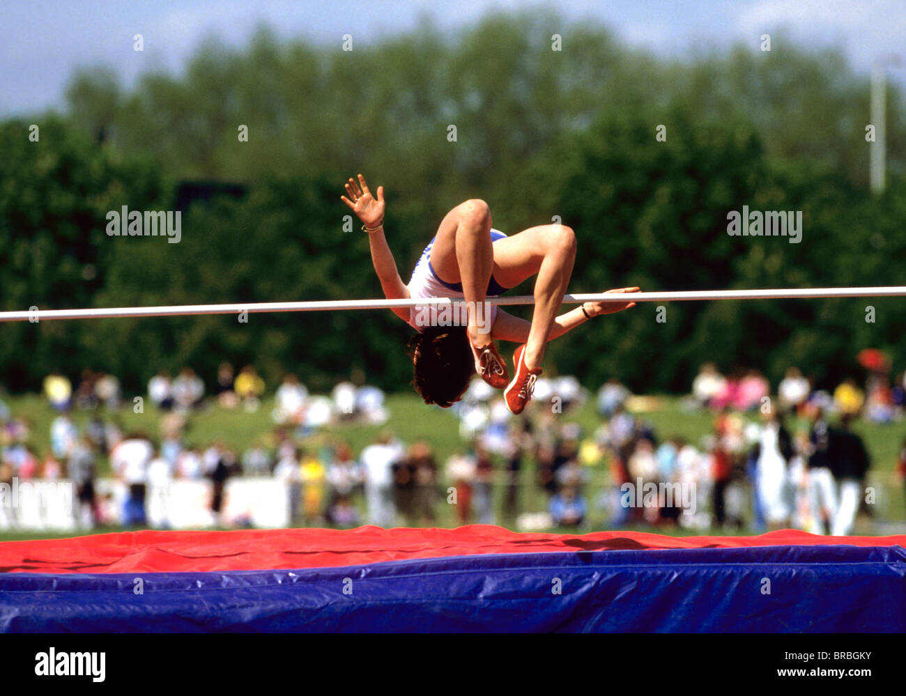 Female high-jumper clears bar on her jump Stock Photo - Alamy