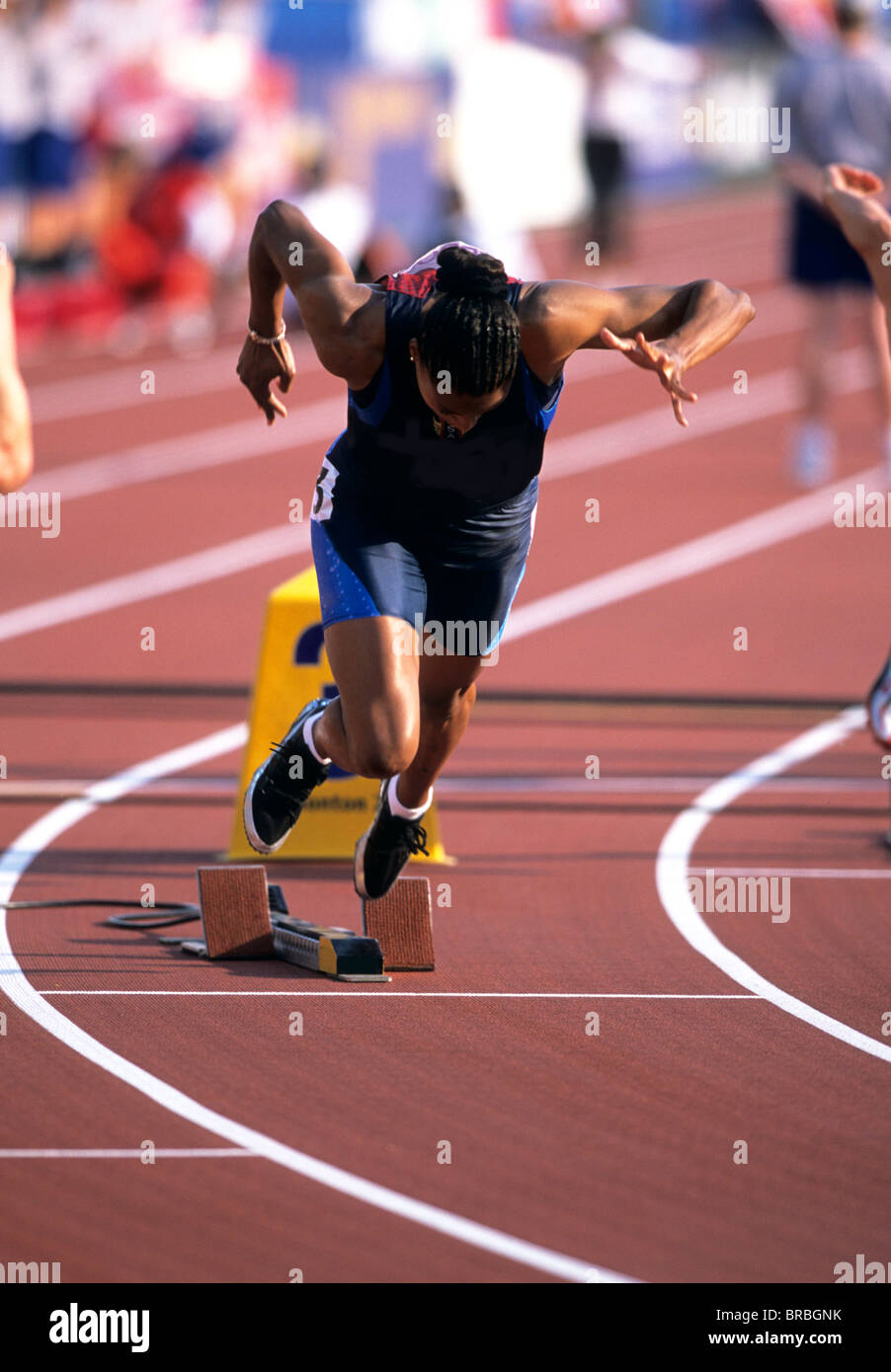 Female sprinter explodes from blocks in 200 meters race Stock Photo - Alamy