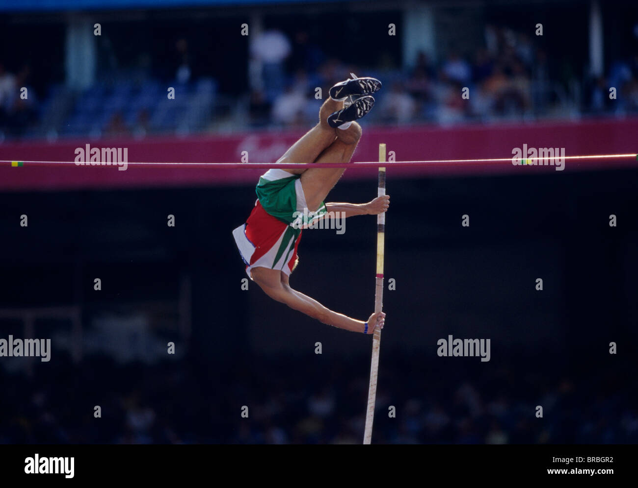 Man pole vaulting Stock Photo - Alamy