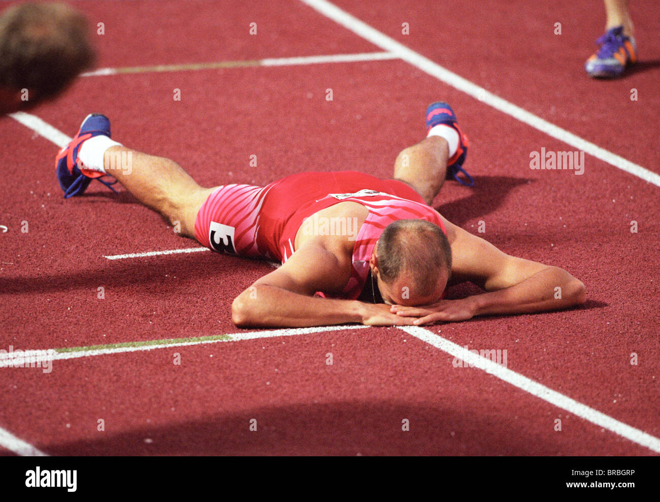 Man lying face down on a race track Stock Photo - Alamy