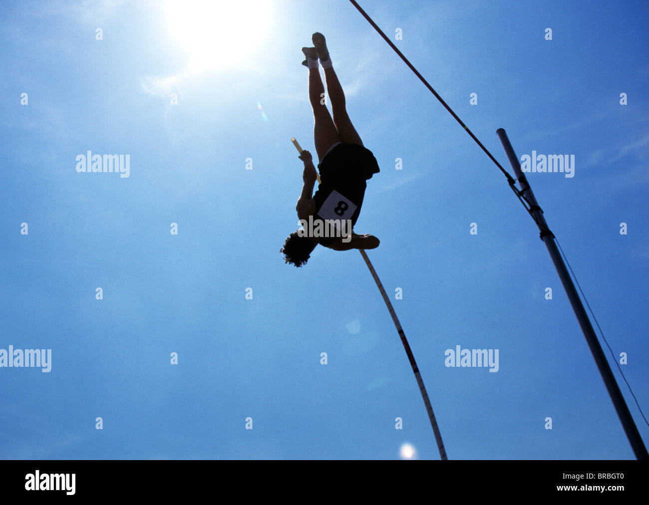 Silhouette of a man pole vaulting Stock Photo - Alamy
