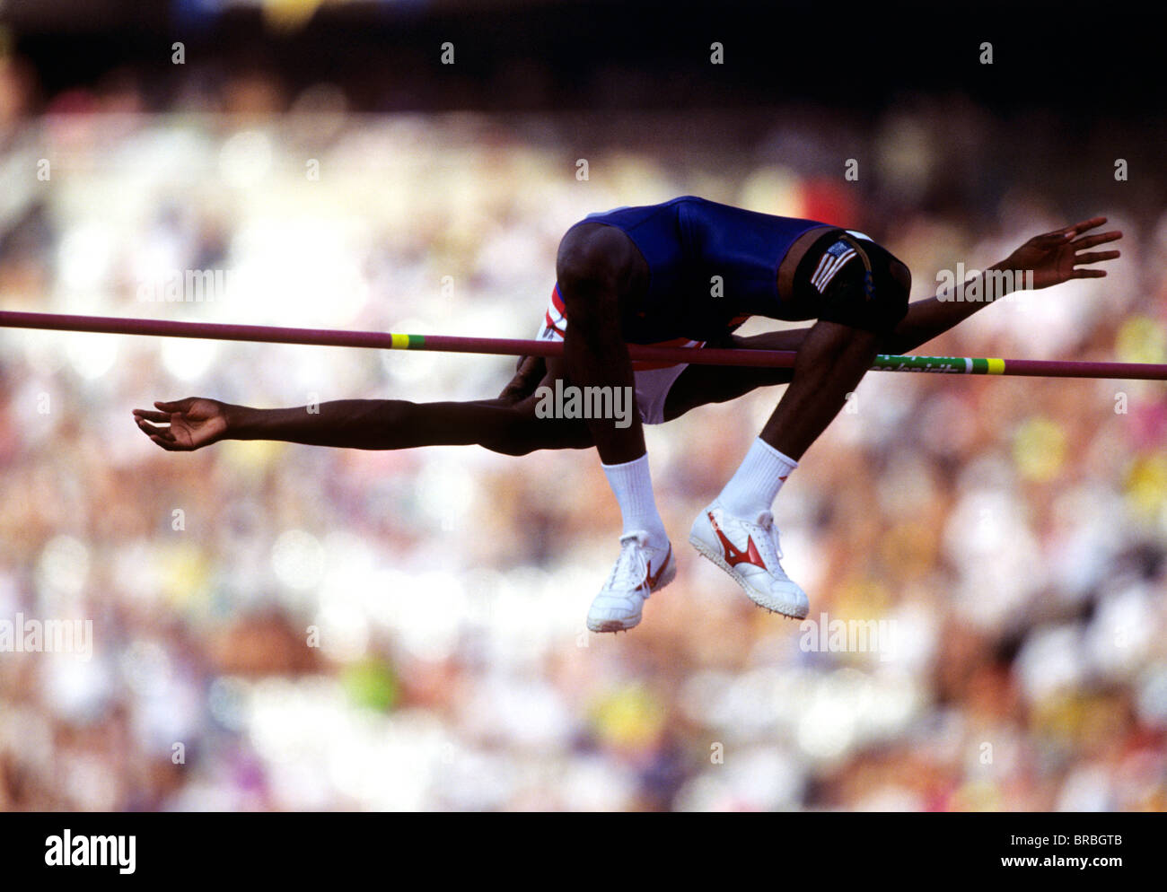 Man clearing the bar of a high jump Stock Photo - Alamy