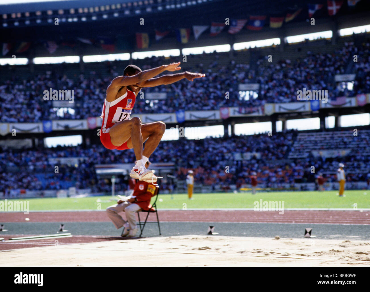 Athlete participating in long jump event Stock Photo - Alamy