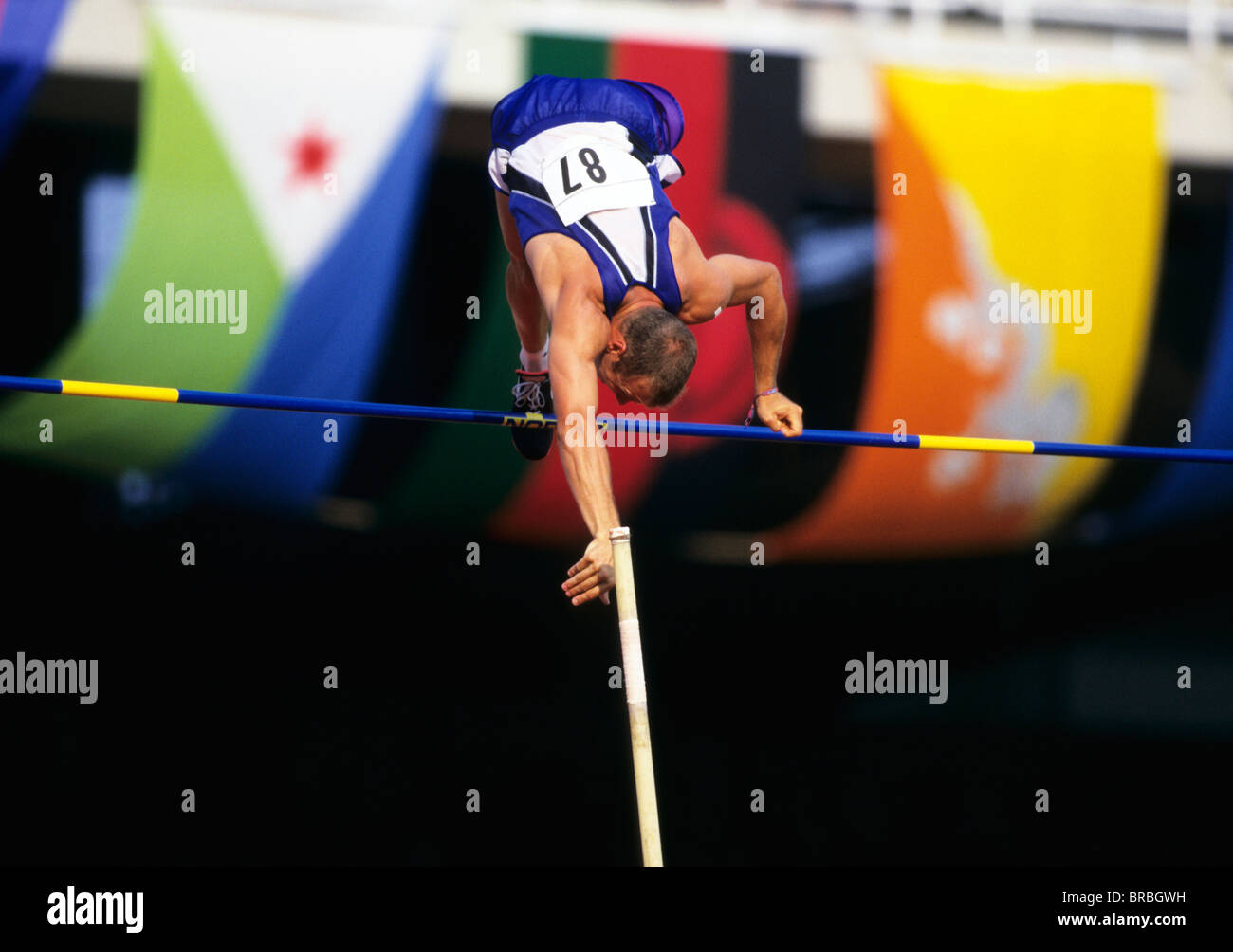 Man clears the bar pole vaulting Stock Photo - Alamy