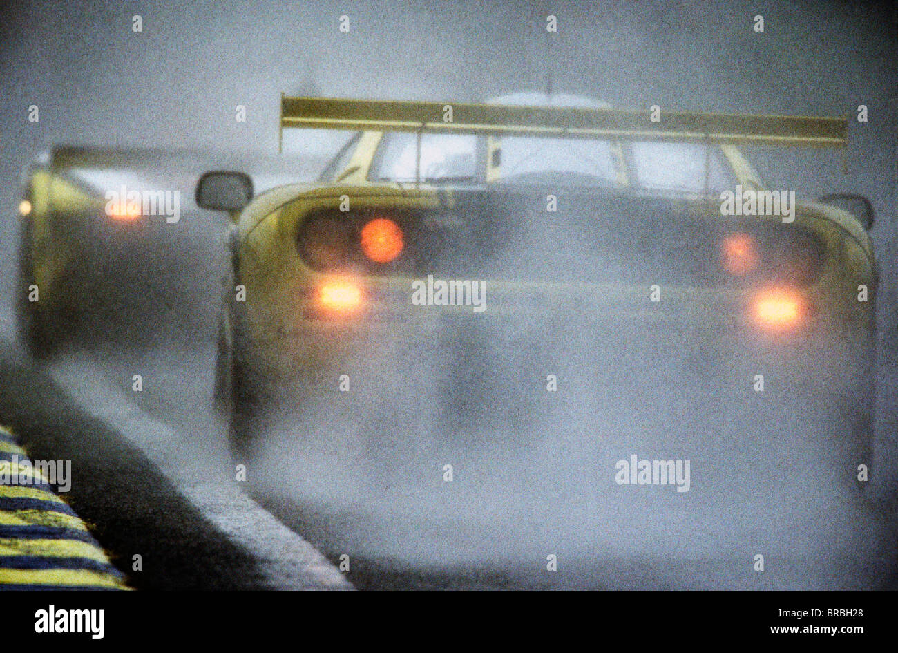 Cars racing in the rain Stock Photo - Alamy