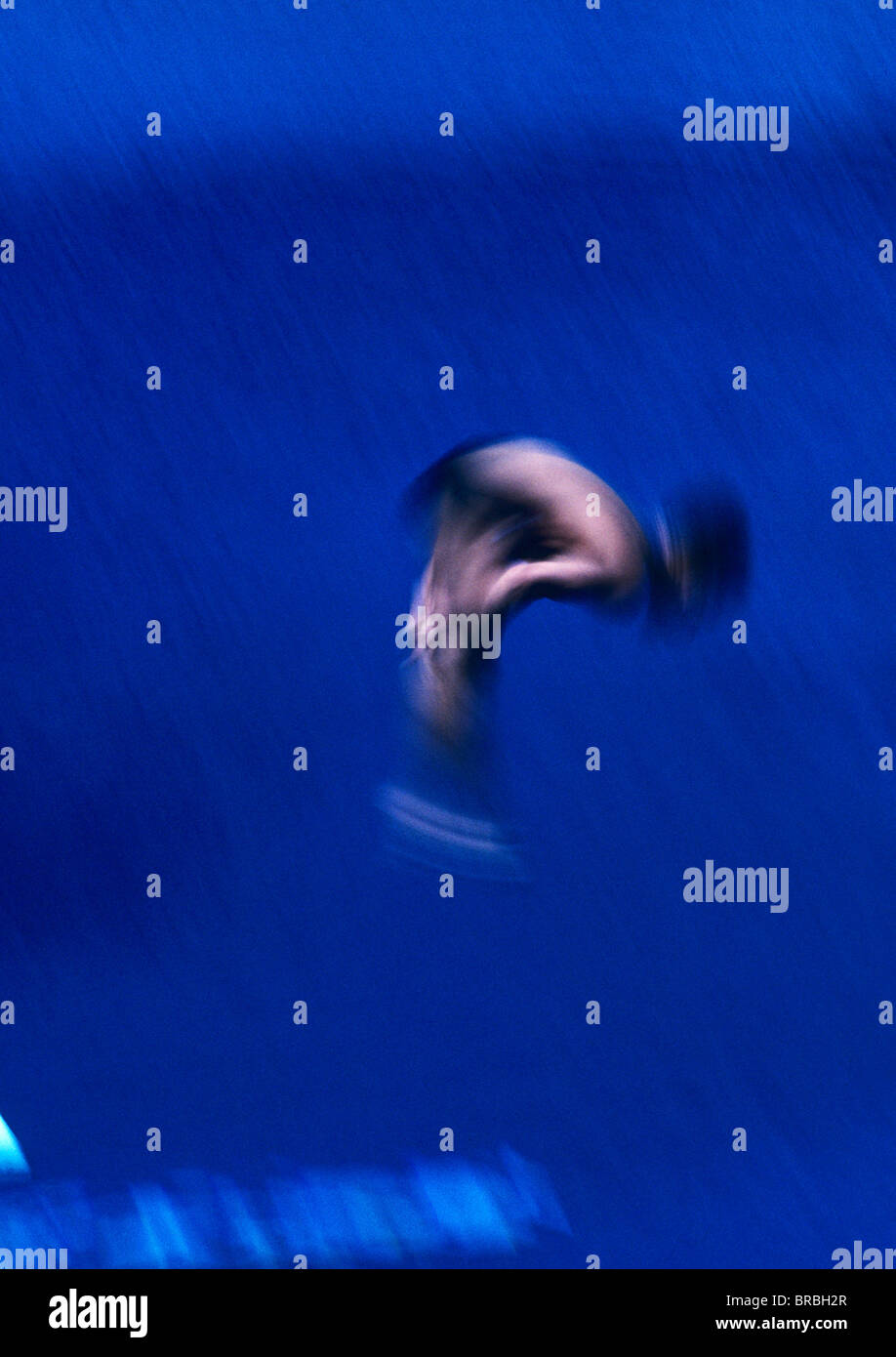 Man performing a high dive Stock Photo - Alamy