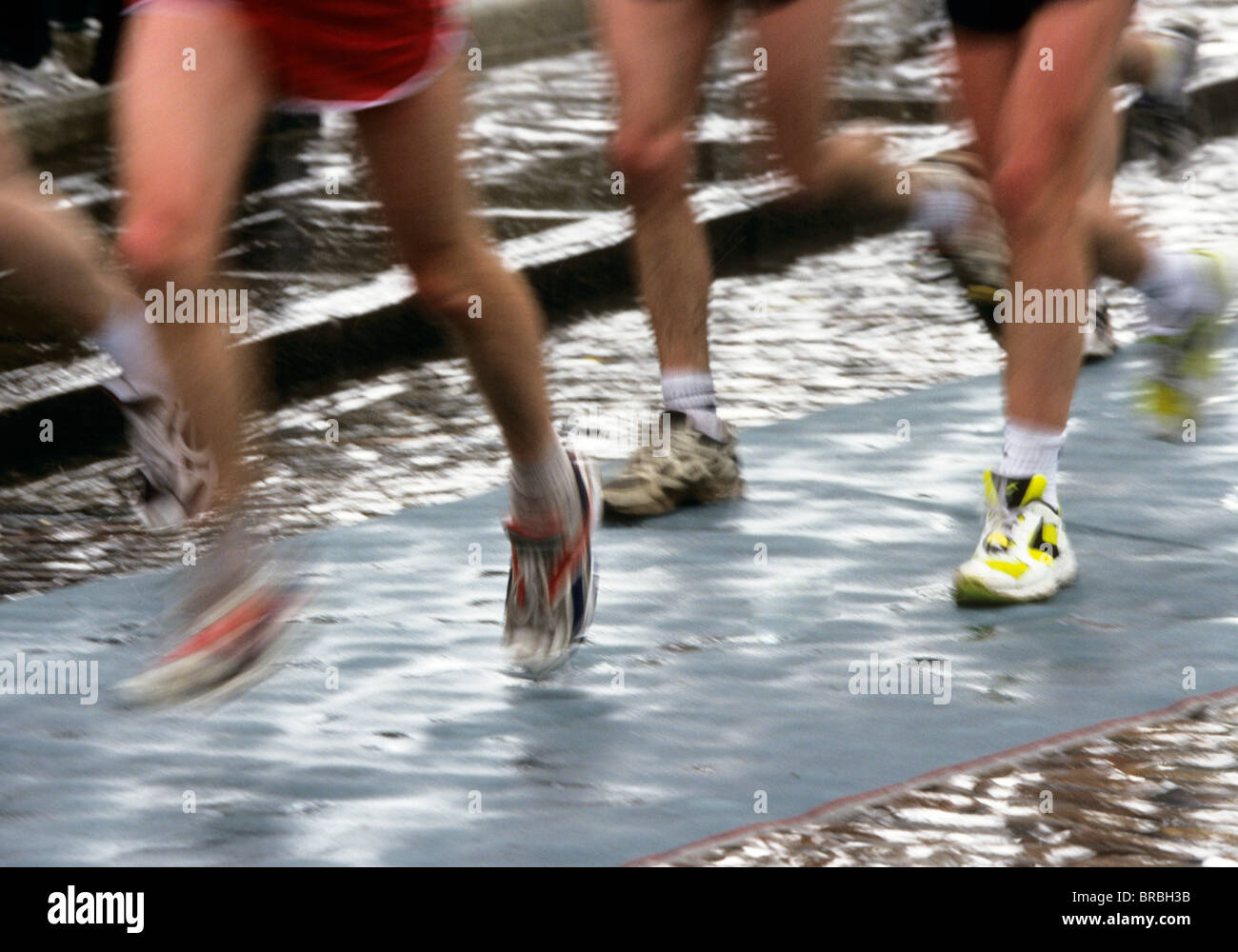 Group of runners in the rain on a road course Stock Photo - Alamy