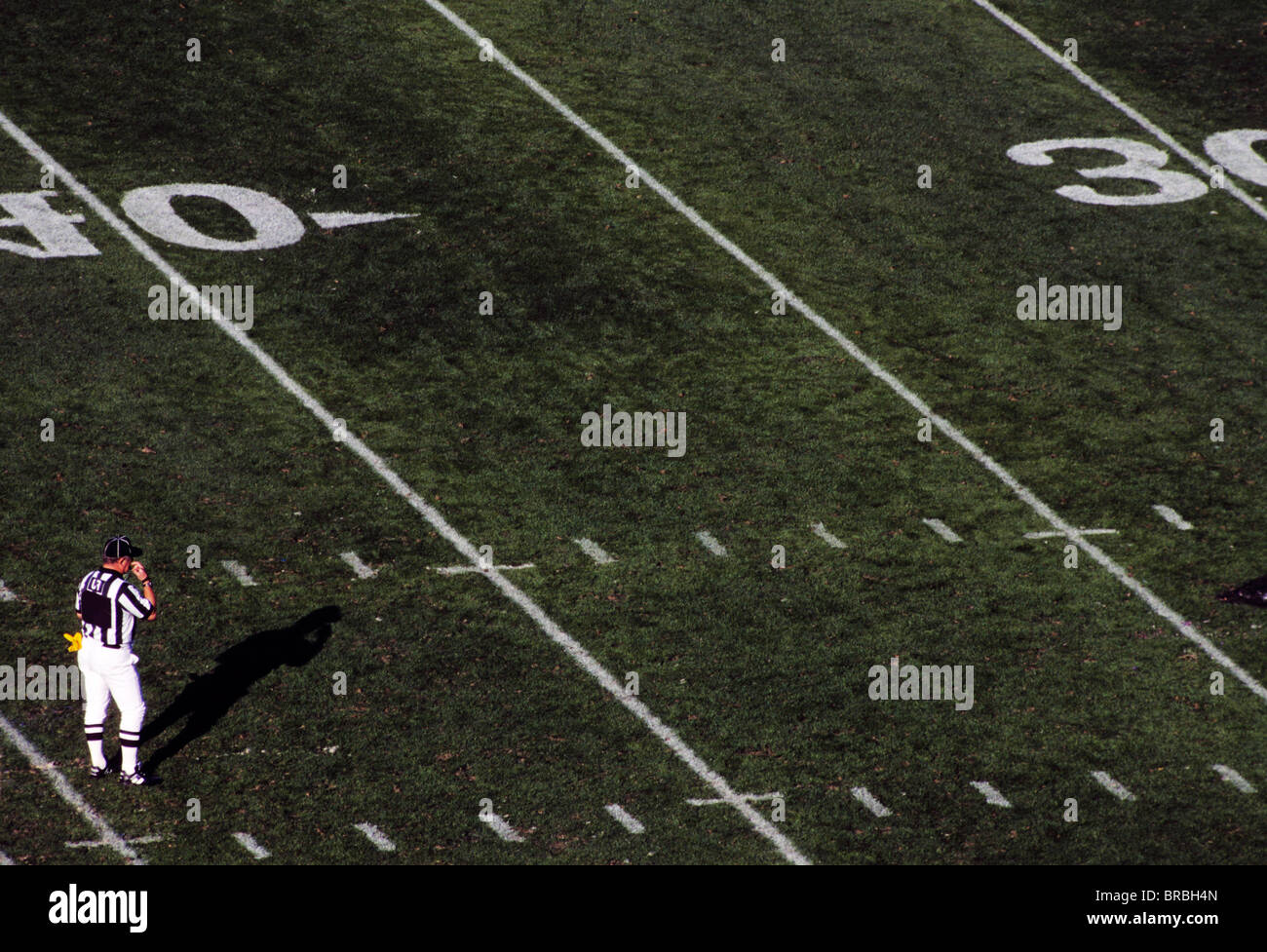 Referee looking down an American football field Stock Photo - Alamy