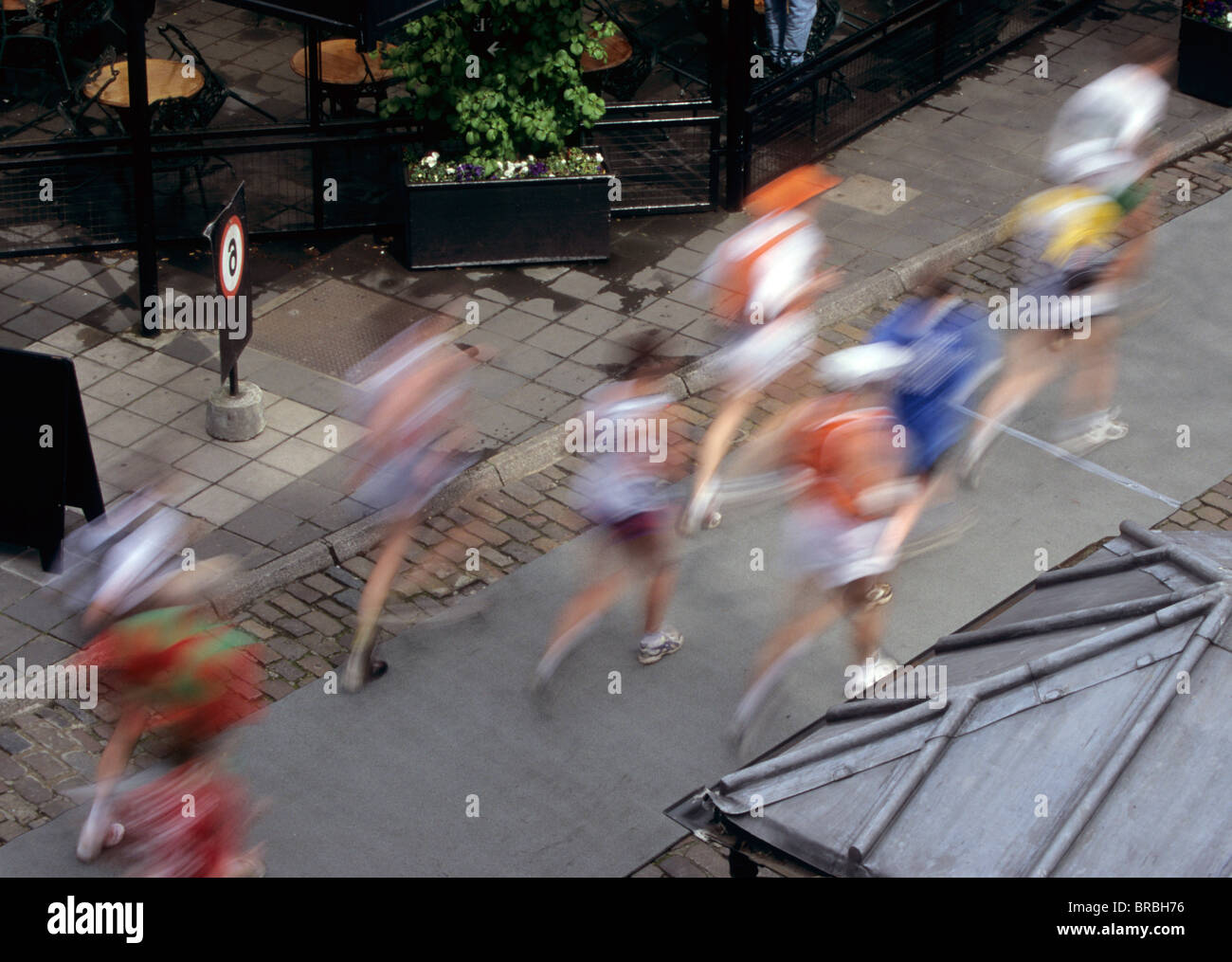 Group of runners running through a street Stock Photo - Alamy