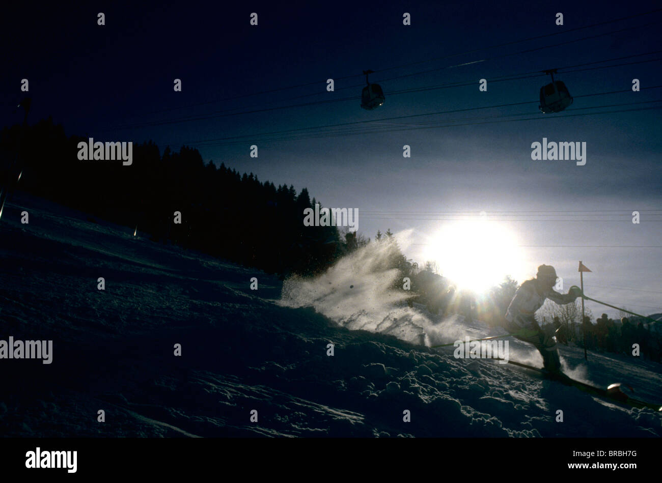 Skier takes a mogul run at sunset Stock Photo - Alamy