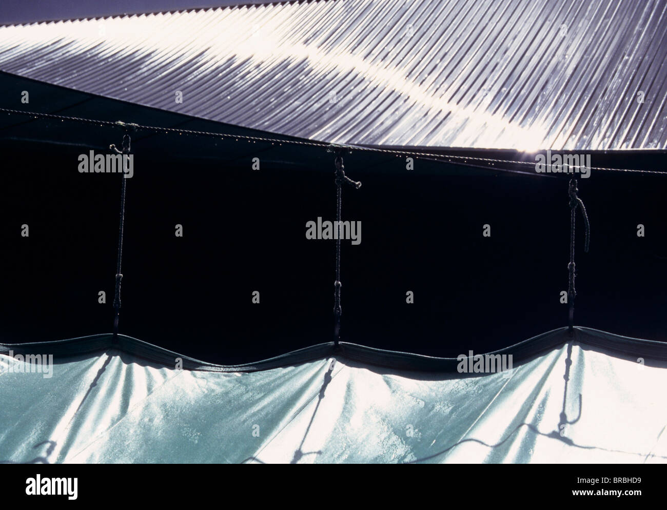 Covers over a tennis court as rain stops play Stock Photo - Alamy
