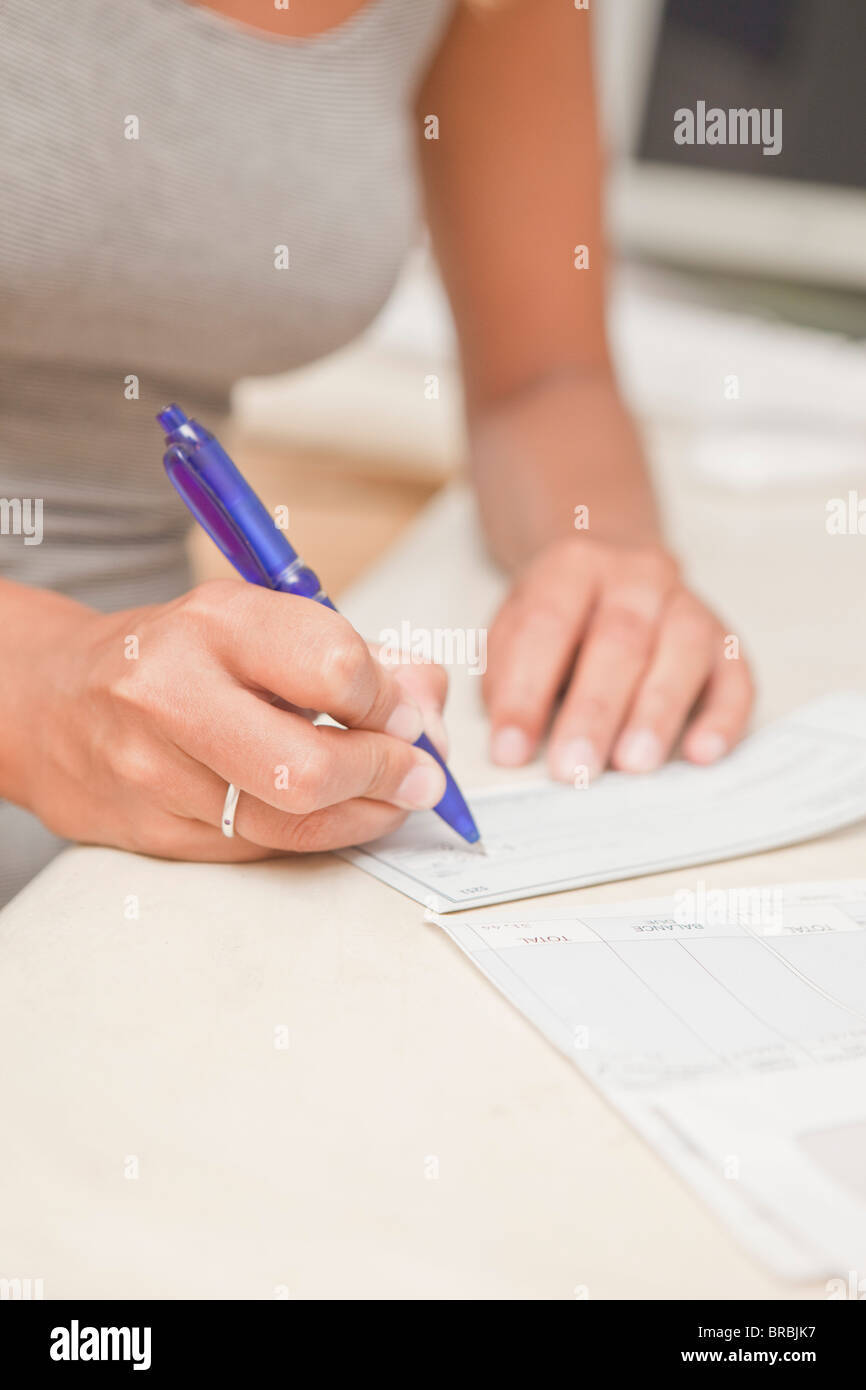 woman's hand writing checks Stock Photo - Alamy
