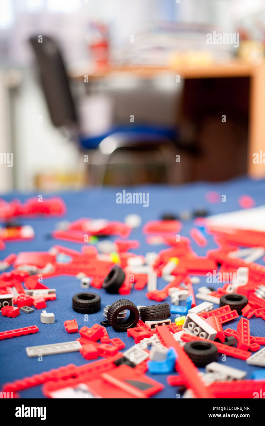 Blue and red small plastic construction set pieces on a bed Stock Photo ...