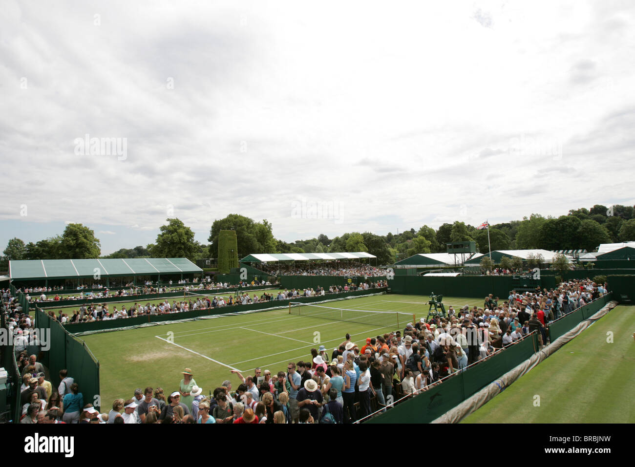 Large crowds watching tennis matches on several grass courts Stock ...