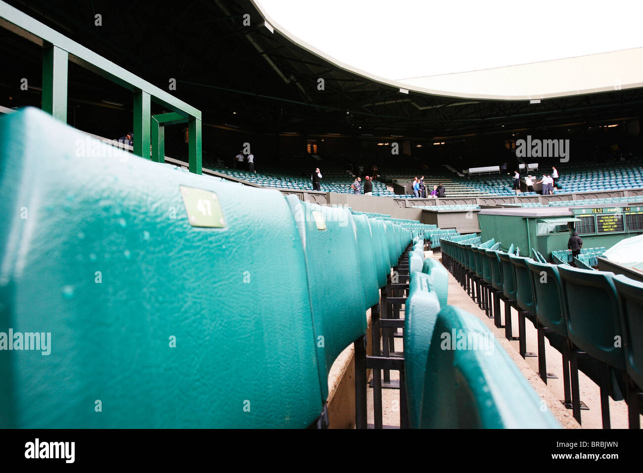 People walking around a stadium in the rain Stock Photo - Alamy