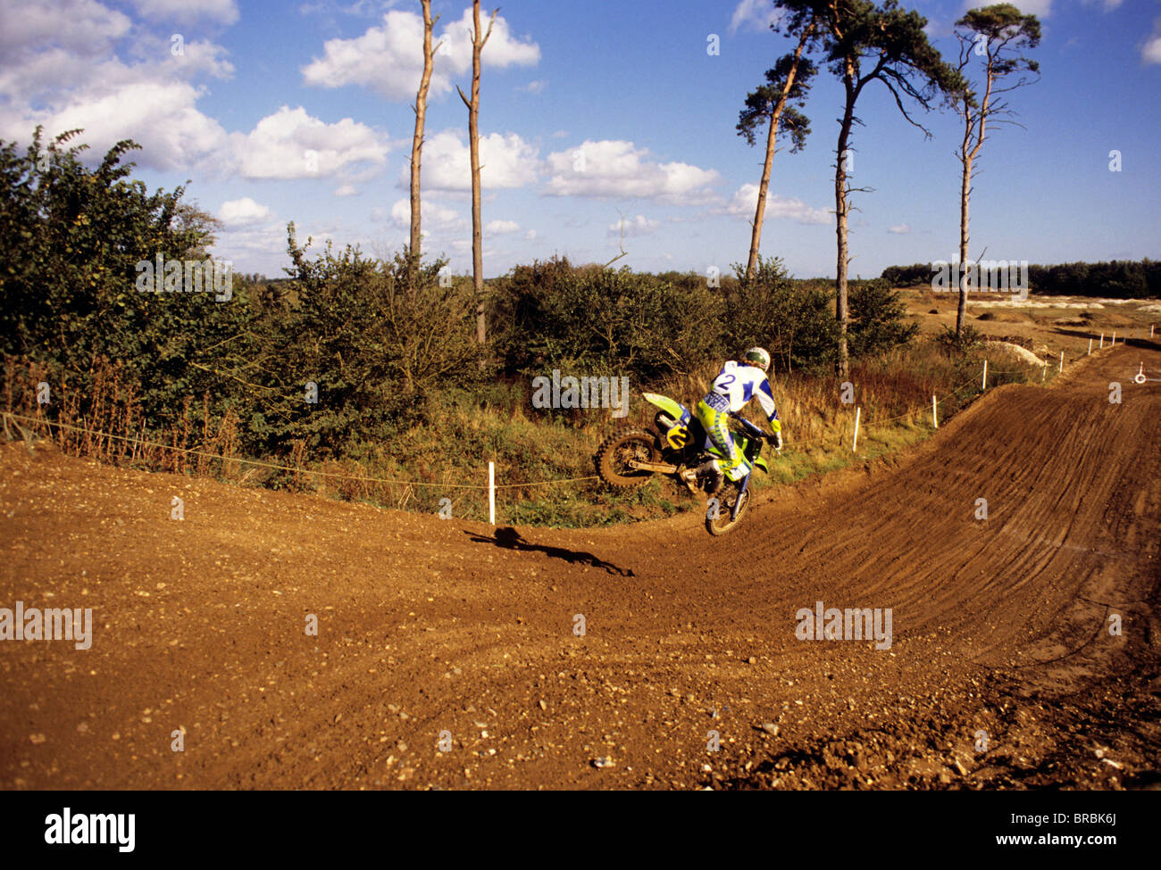 Man landing a jump on a motorcycle on dirt track race Stock Photo - Alamy