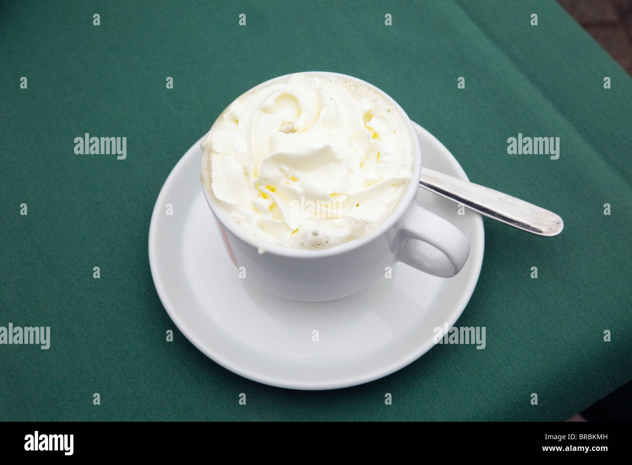 Europe. Cappuccino coffee with whipped cream on top in a cup and saucer ...