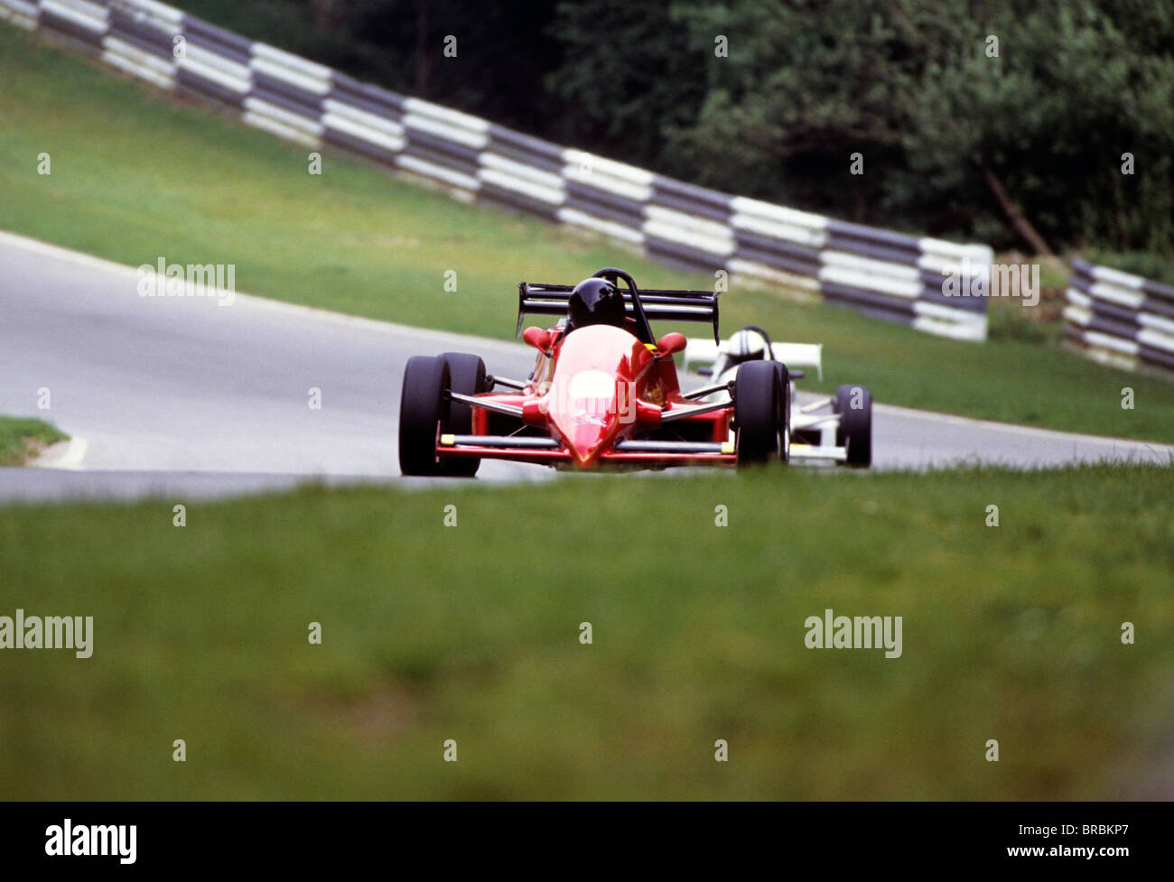 Two Formula one cars racing through a corner Stock Photo - Alamy