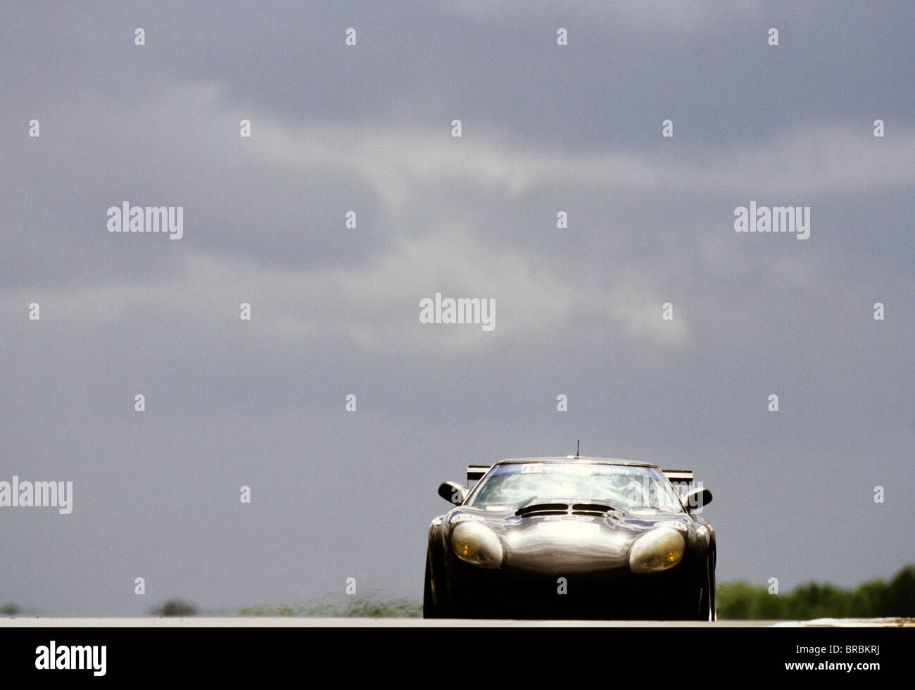 Race car against the dark sky Stock Photo - Alamy