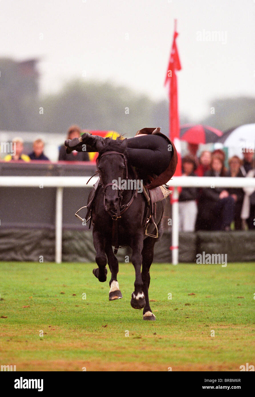 Trick horse rider turns over his saddle Stock Photo - Alamy