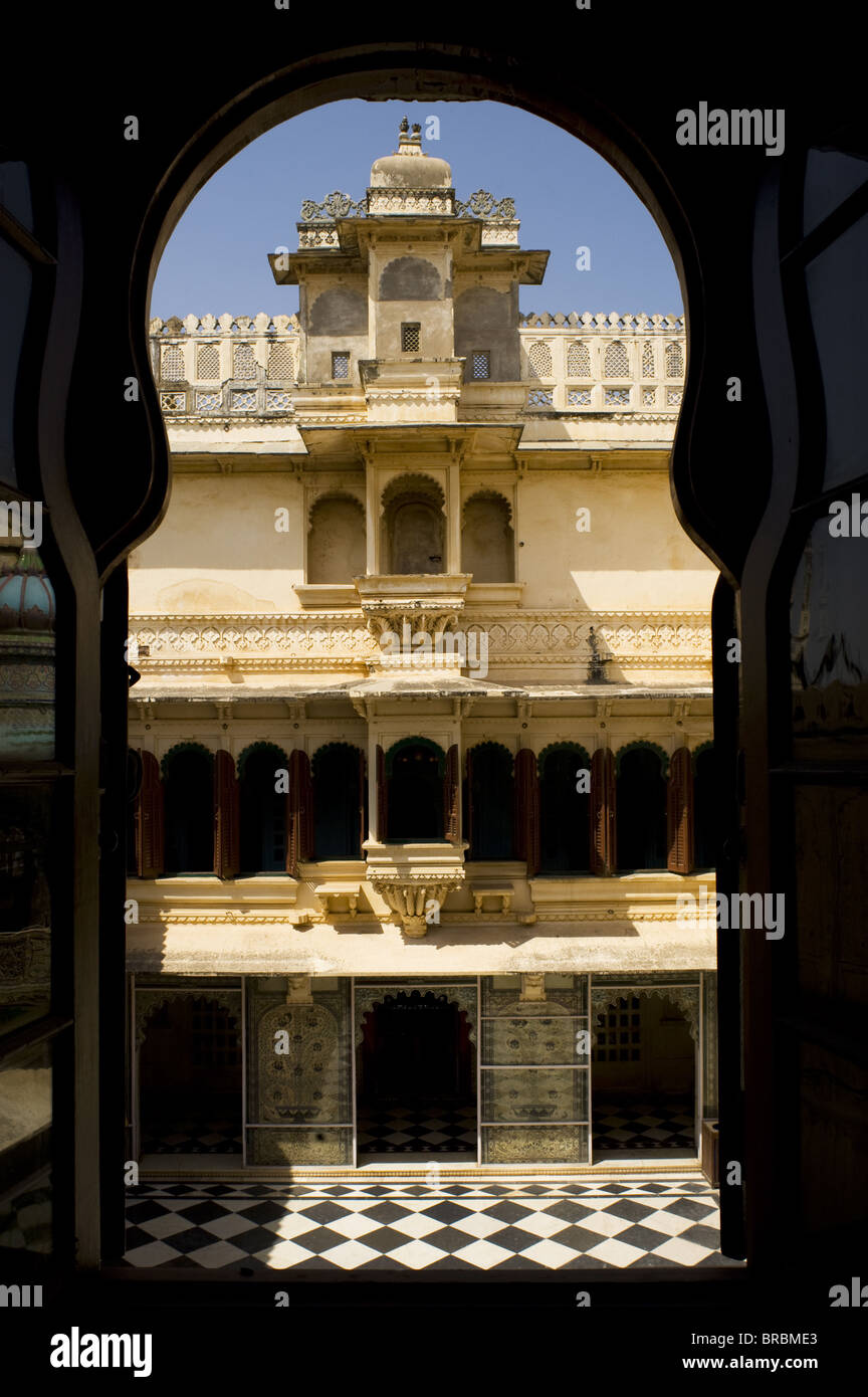 A section of The City Palace viewed through an arched window, Udaipur ...