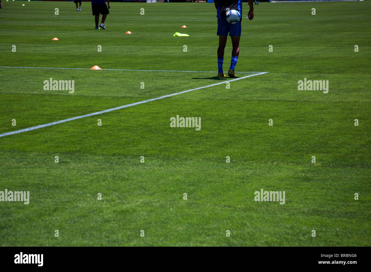 Footballers warm up pre-game on pitch Stock Photo - Alamy